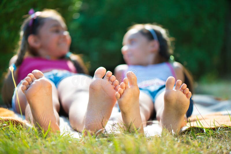 Two Happy Sisters Lying on Green Grass Stock Image - Image of fitness ...