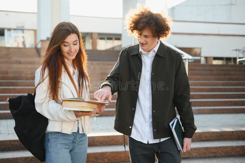 Two Happy Students Walking Towards Camera and Talking in a University ...