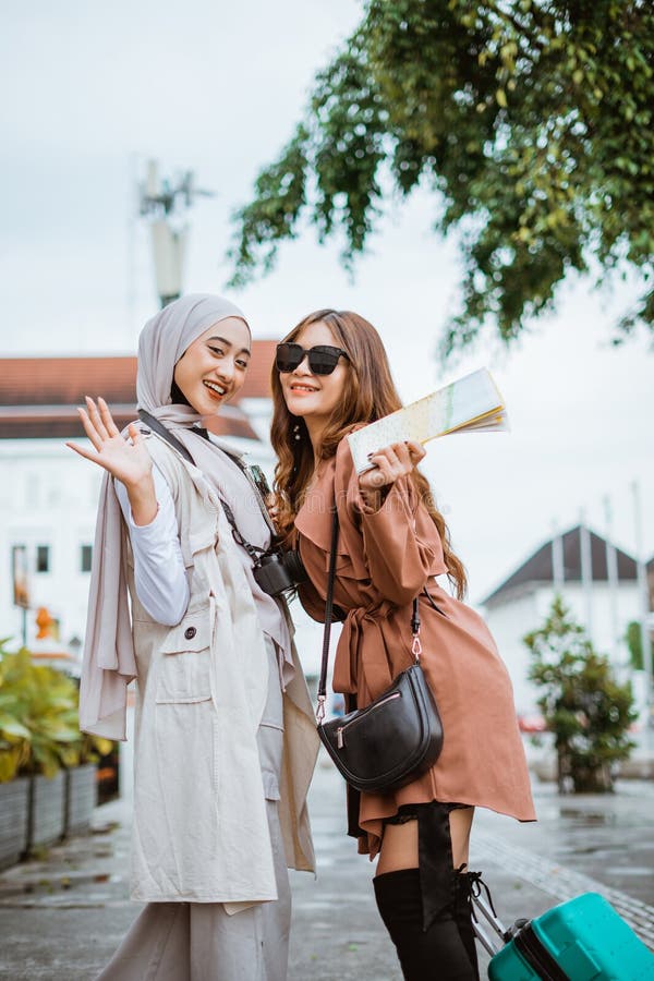 Two Happy Travellers Standing Facing Each Other Stock Photo - Image of ... Two Happy Travellers Standing Facing Each Other Stock Photo - Image of ...
