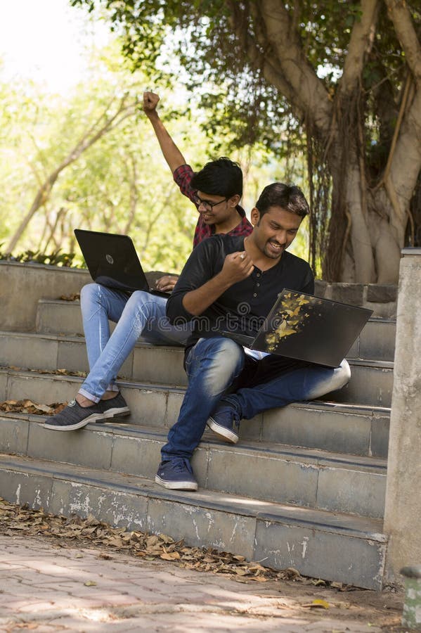 Happy Young Students Working on Laptop in Park Stock Photo - Image of ...