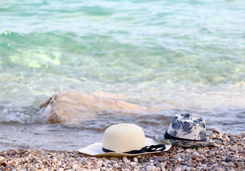 Two hats on the beach stock photo. Image of beautiful - 148571092