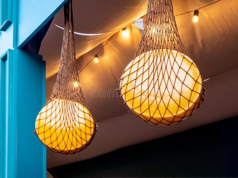 Two Heads of Cheese Suspended in Mesh Stock Image - Image of product ...