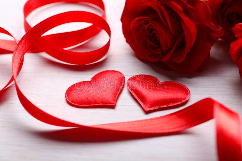 Two Hearts, Ribbon and Red Roses on Table Stock Photo - Image of ...