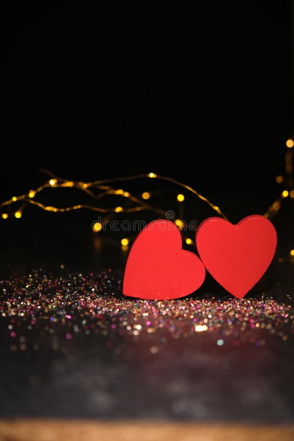 Two Hearts Side by Side on a Dark Background and Garlands Stock Image ...