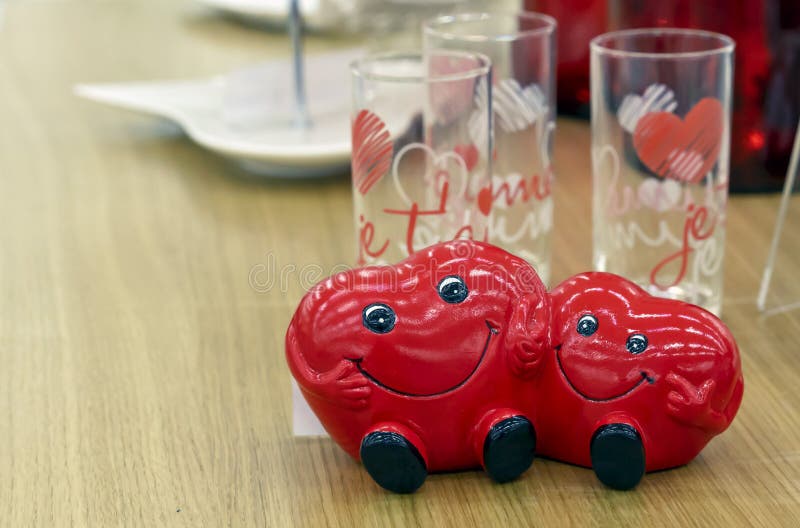 Two Hearts are Smiling and Holding Hands. Ceramic Figurine of Two ...