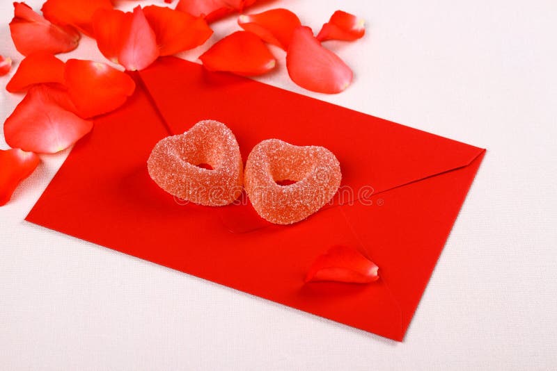 Two Hearts from Sugar Candies on Red Envelope and Petals Stock Image ...
