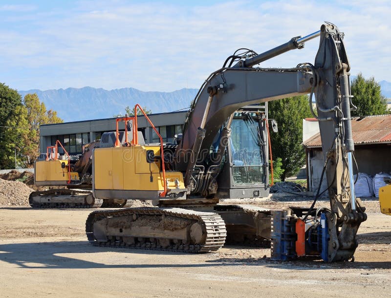 Two Heavy Excavators in the Construction Site during a Redevelopment ...