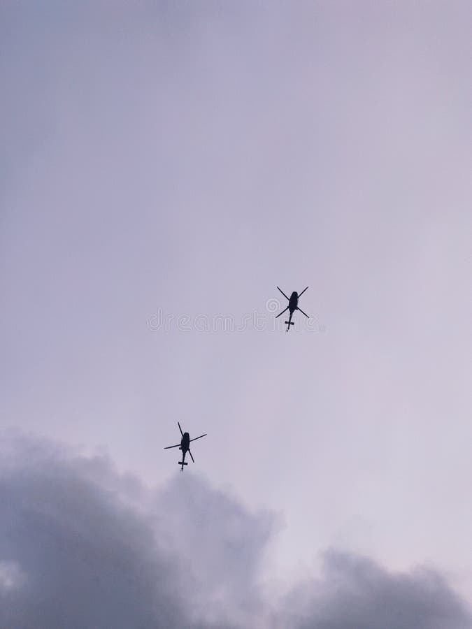 Two helicopters flying stock photo. Image of flying - 235379404