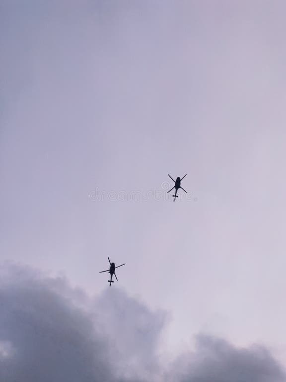 Two helicopters flying stock photo. Image of flying - 235379404