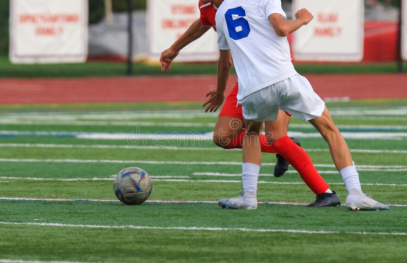 Two Boys Going for the Soccer Ball during a Game Stock Photo - Image of ...