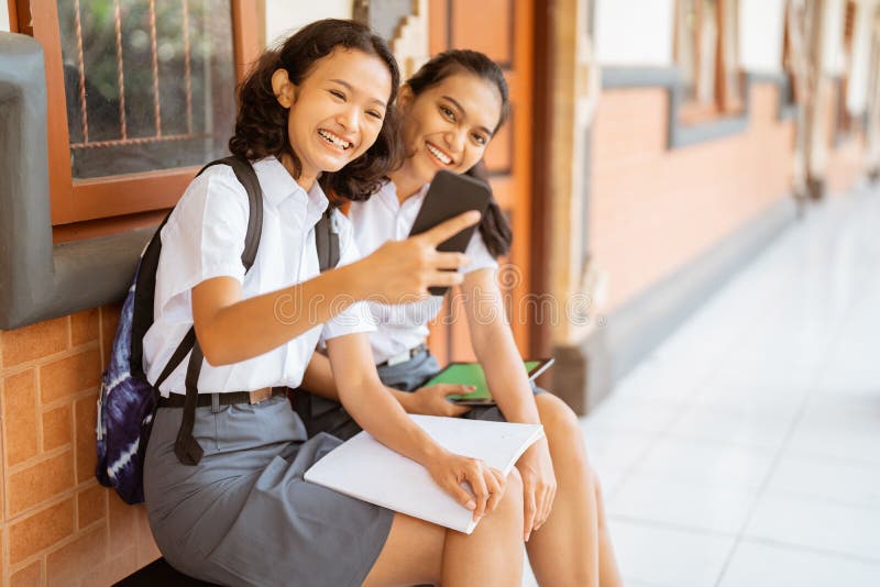 Two High School Students Smiling while Taking Selfies Outside Stock ...