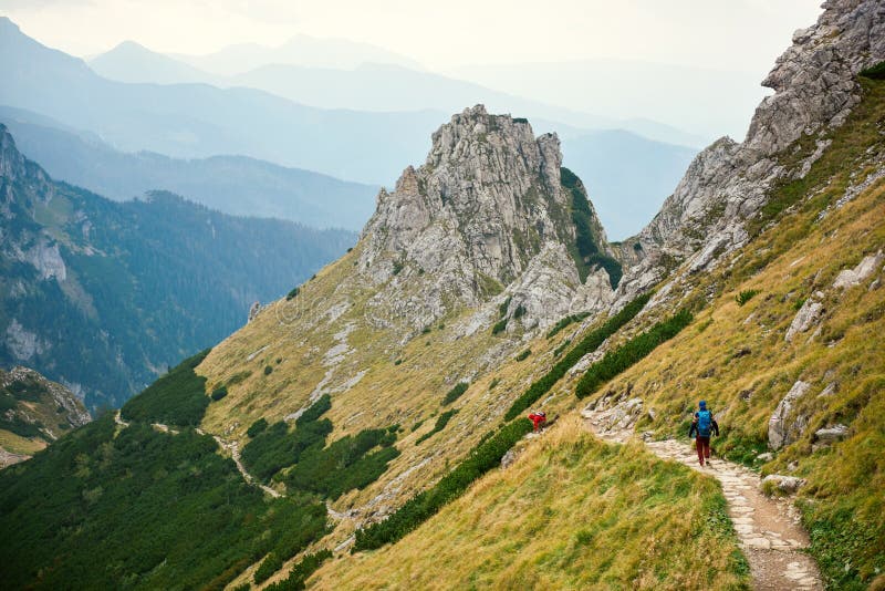 Two Hikers Walking Along a Trail in the Mountains Stock Image - Image ... Two Hikers Walking Along a Trail in the Mountains Stock Image - Image ...