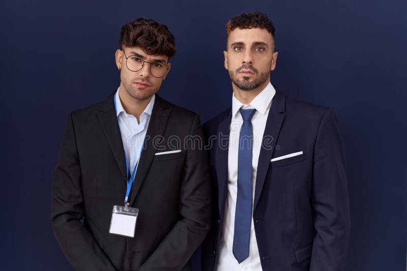Two Hispanic Business Men Wearing Business Clothes Relaxed with Serious ...
