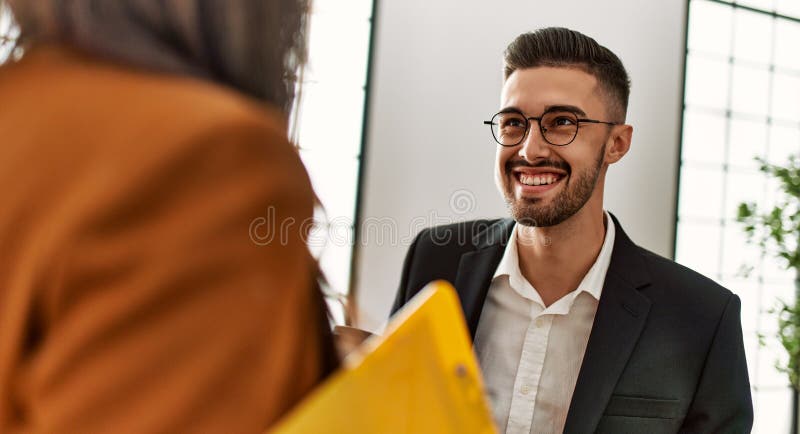 Two Hispanic Business Workers Smiling Happy Talking at the Office Stock ...