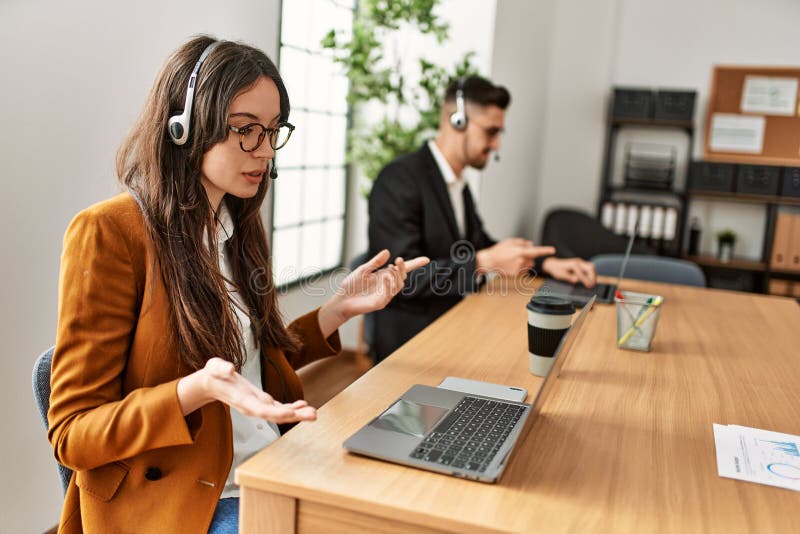 Two Hispanic Call Center Agents Working at the Office Stock Image ...