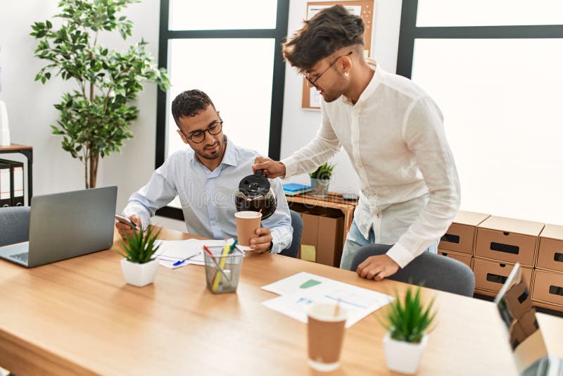 Two Hispanic Men Business Workers Pouring Coffee Working at Office ...
