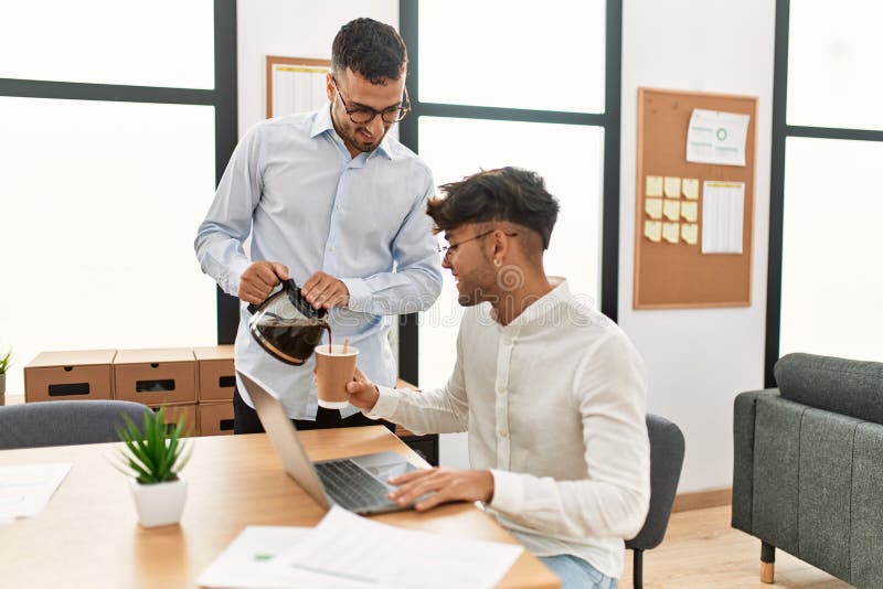 Two Hispanic Men Business Workers Pouring Coffee Working at Office ...