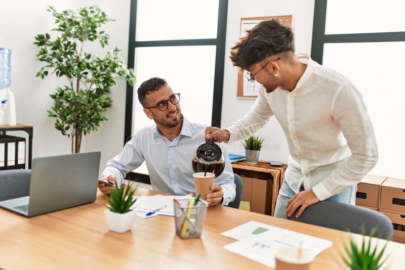 Two Hispanic Men Business Workers Pouring Coffee Working at Office ...