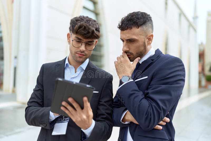 Two Hispanic Men Business Workers Using Touchpad Working at Street ...