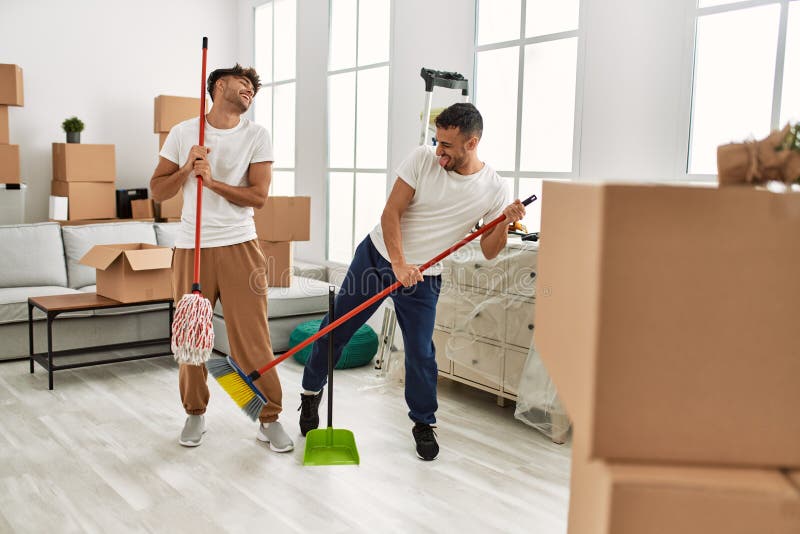 Two Hispanic Men Couple Cleaning and Dancing at New Home Stock Image ...