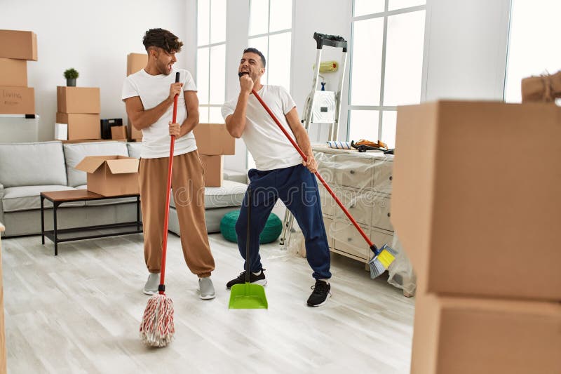 Two Hispanic Men Couple Cleaning and Dancing at New Home Stock Image ...