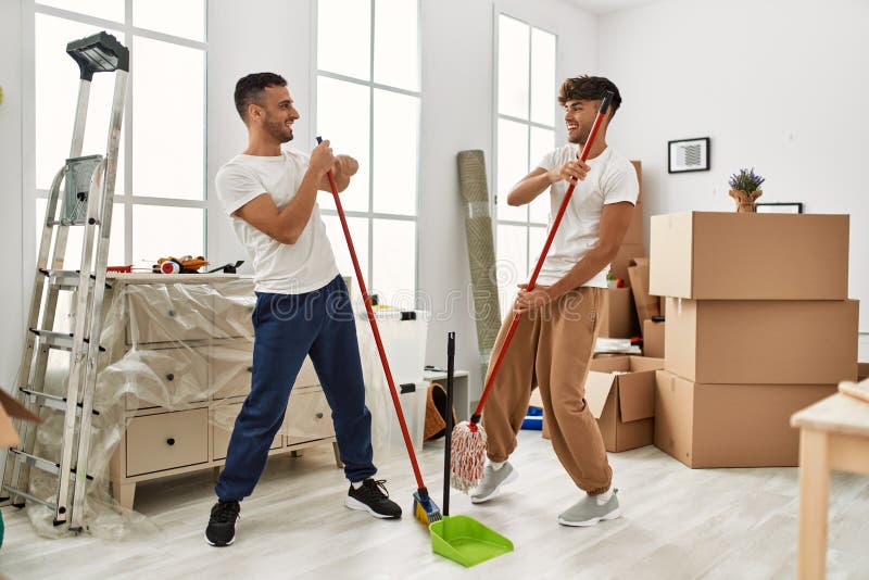 Two Hispanic Men Couple Cleaning and Dancing at New Home Stock Image ...