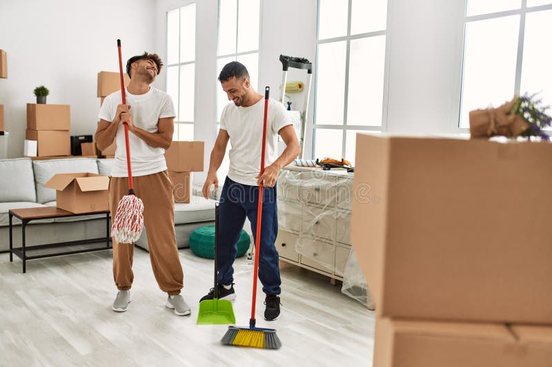 Two Hispanic Men Couple Cleaning and Dancing at New Home Stock Image ...