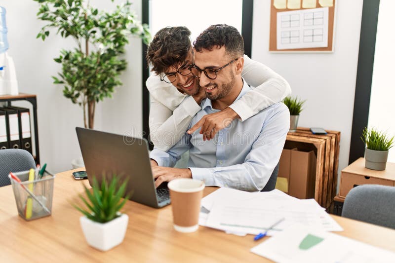Two Hispanic Men Couple Hugging Each Other Working at Office Stock ...