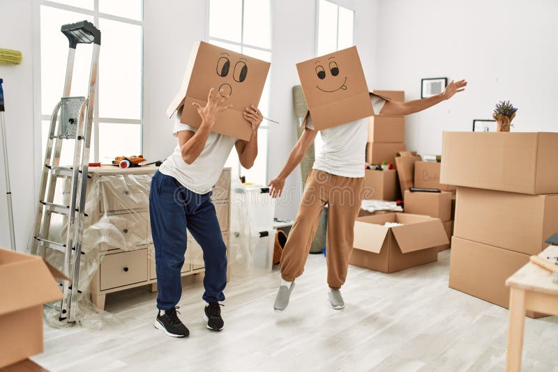 Two Hispanic Men Couple Playing with Funny Cardboard Boxes on Head at ...