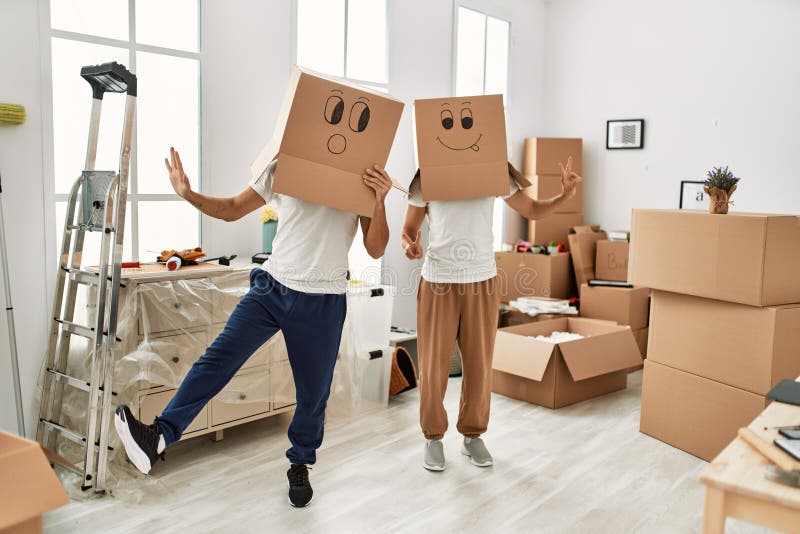 Two Hispanic Men Couple Playing with Funny Cardboard Boxes on Head at ...
