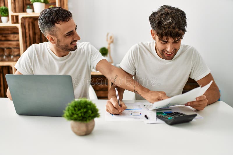 Two Hispanic Men Couple Smiling Confident Using Laptop Working at Home ...