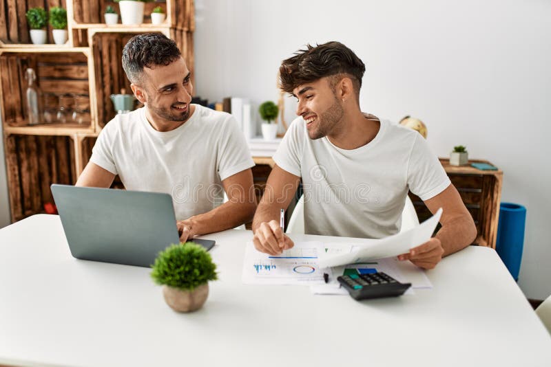 Two Hispanic Men Couple Smiling Confident Using Laptop Working at Home ...