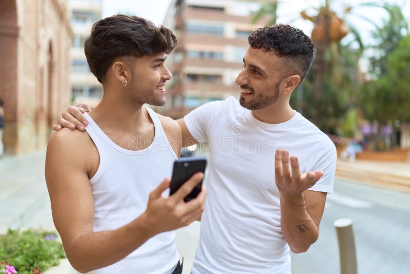 Two Hispanic Men Couple Smiling Confident Using Smartphone at Street ...