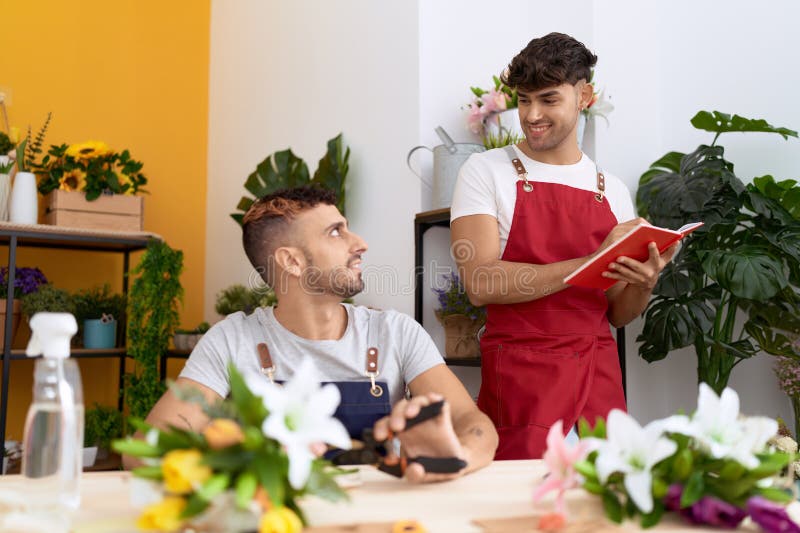 Two Hispanic Men Florists Cutting Stem of Flower Writing on Notebook at ...