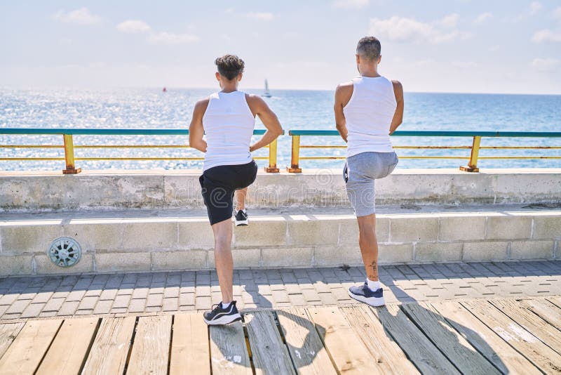 Two Hispanic Men Sporty Couple on Back View Stretching at Seaside Stock ...