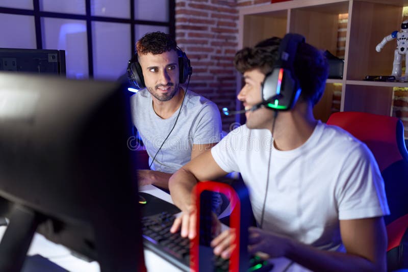 Two Hispanic Men Streamers Playing Video Game Using Computer at Gaming ...