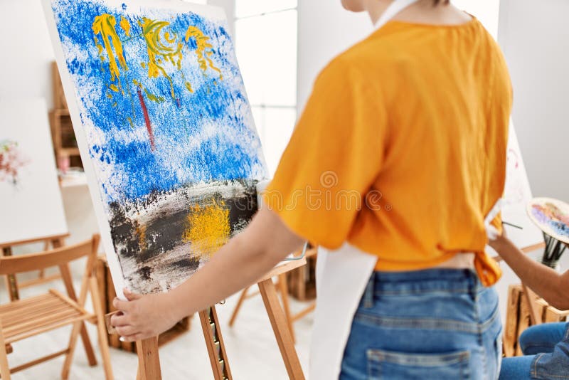 Two Hispanic Paint Students on Back View Painting at Art Studio Stock ...