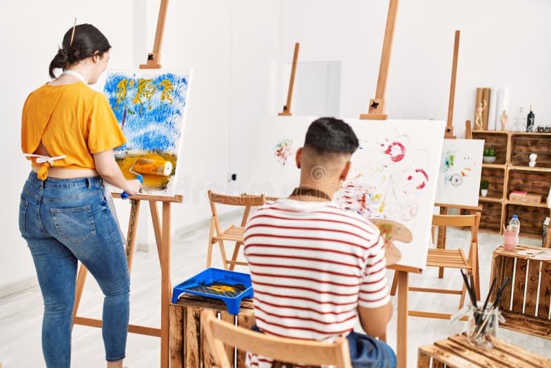 Two Hispanic Paint Students on Back View Painting at Art Studio Stock ...