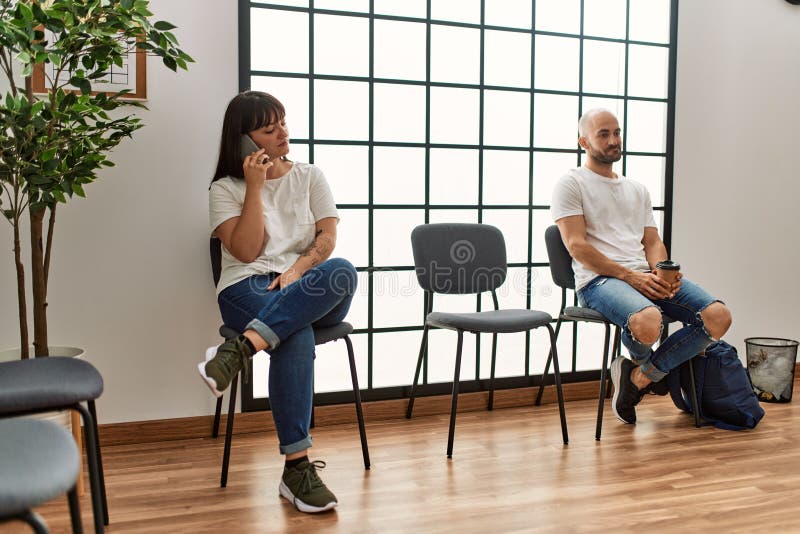 Two Hispanic Person Boring Talking on the Smartphone at Waiting Room ... Two Hispanic Person Boring Talking on the Smartphone at Waiting Room ...