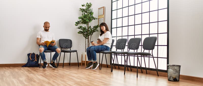 Two Hispanic Person Boring Using Smartphone and Reading Book at Waiting ...