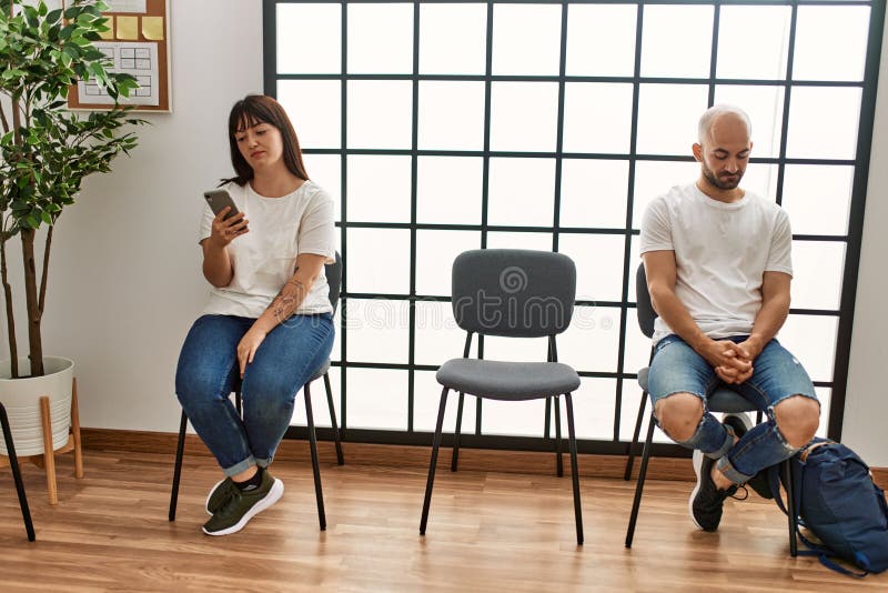 Two Hispanic Person Boring Using Smartphone at Waiting Room Stock Photo ...