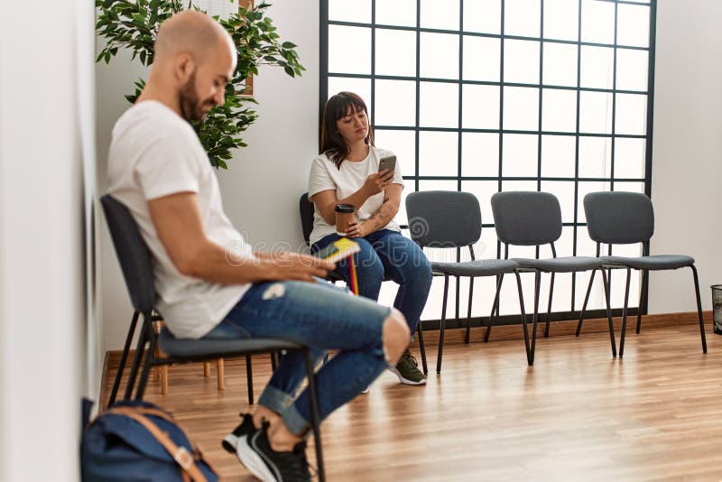 Two Hispanic Person Boring Using Smartphone at Waiting Room Stock Photo ...