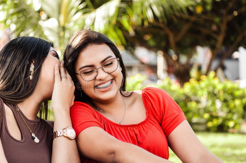 Two Hispanic Smiling Girls Having a Conversation in a Park. Stock Photo ...