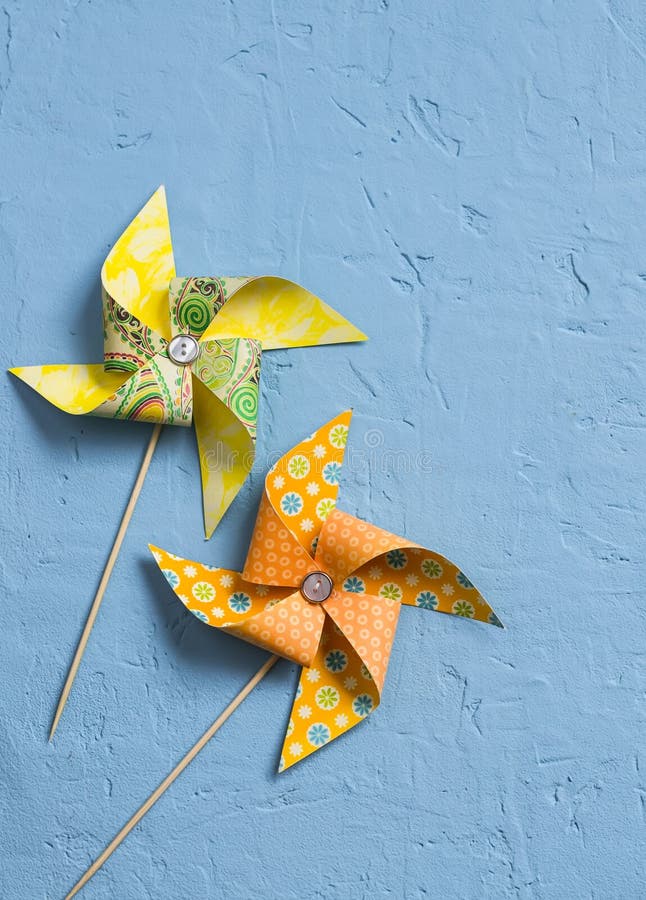 Two Homemade Paper Pinwheel on a Blue Stone Background. Stock Photo ...