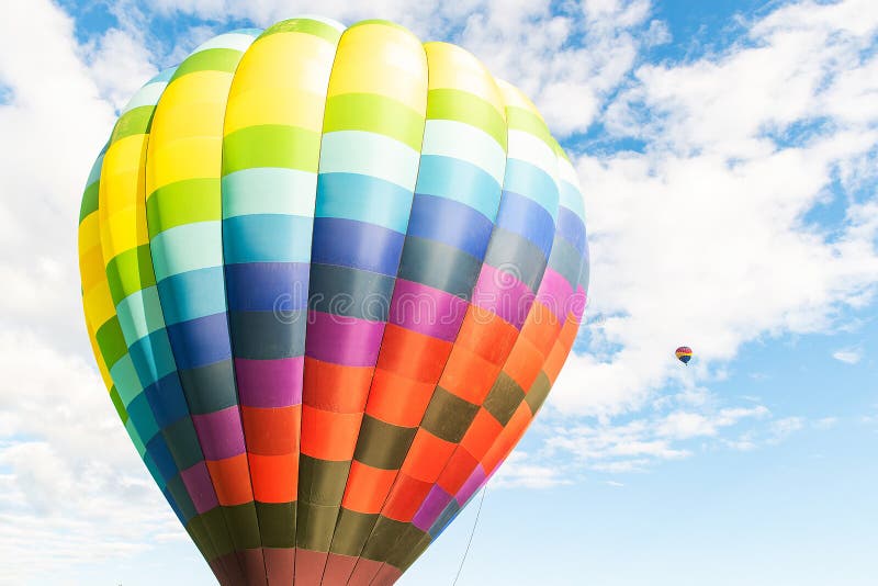 Two Hot Air Balloons Floating Under Vibrant Blue Sky with Puffy White ...