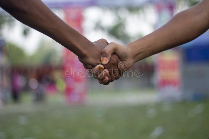 Two Human Hands Joined Together in Partnership and the Background Blur ...