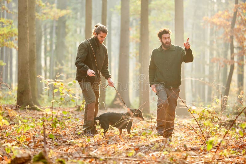 Two Hunters with Hunting Dog on the Prowl Stock Photo - Image of round ...