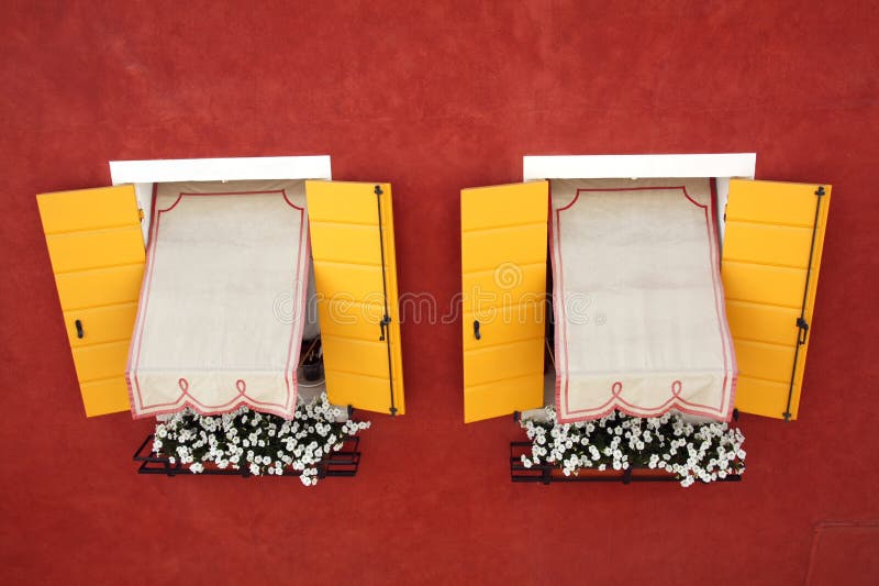 Two Identical Yellow Windows on Red Wall Stock Photo - Image of ...
