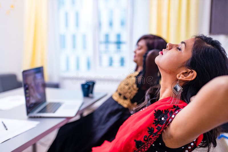 Two Indian Colleages Discussing Ideas Using a Tablet Computer at the ...