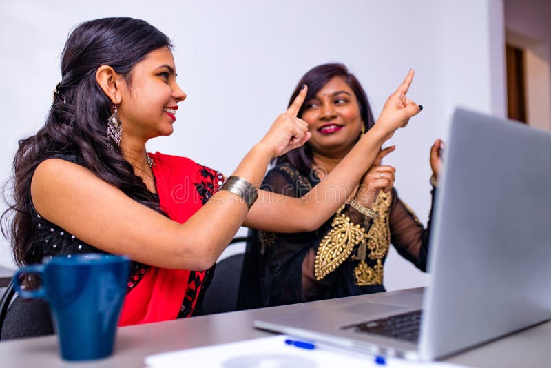 Two Indian Colleages Discussing Ideas Using a Tablet Computer at the ...